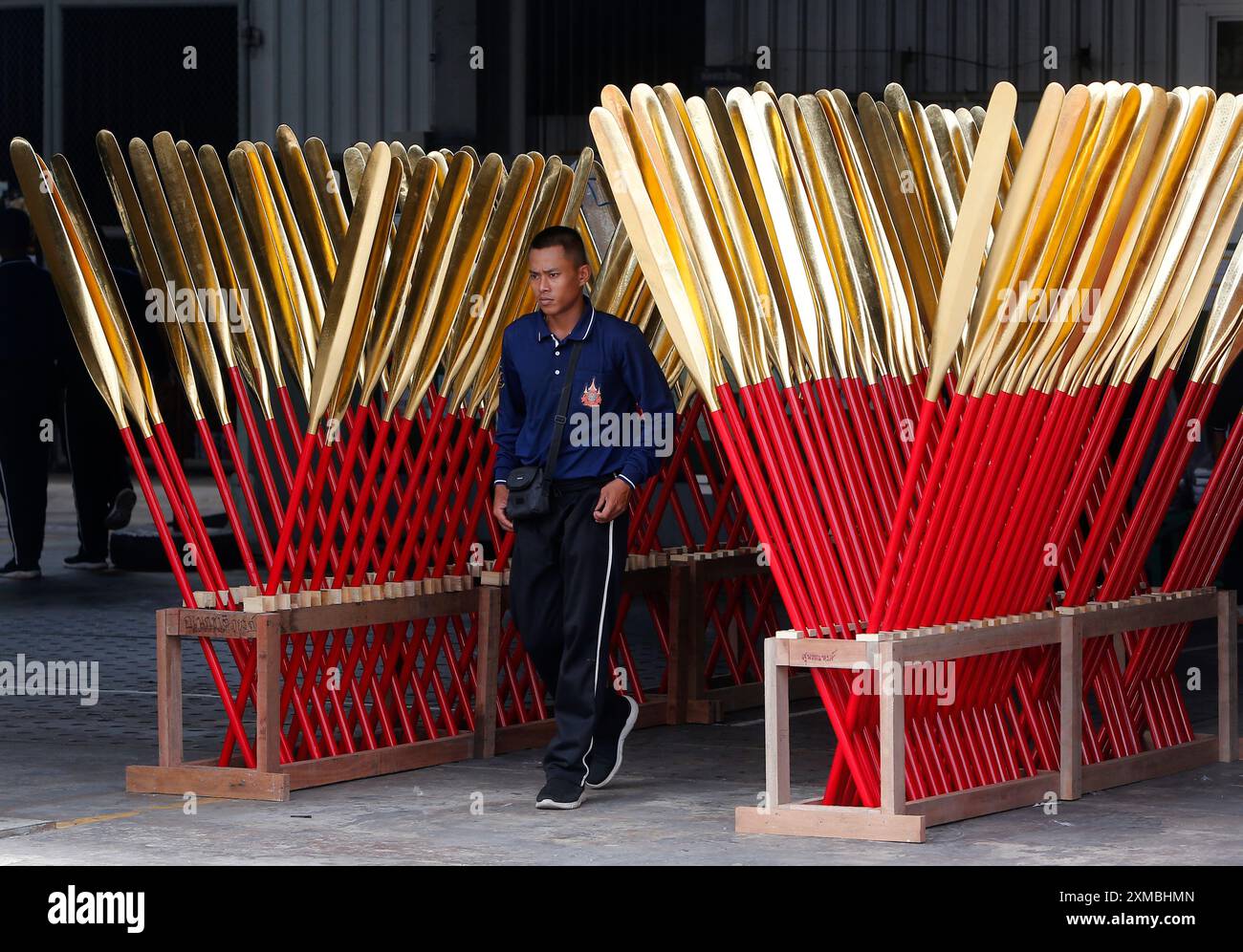 A Thai oarsman walks past oars at the Royal Thai Naval Dockyard in ...