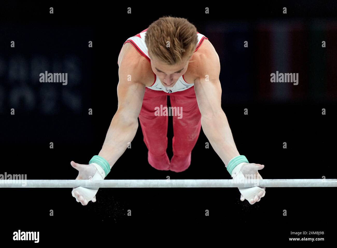 Felix Dolci, of Canada, competes on the horizontal bar during a men's ...