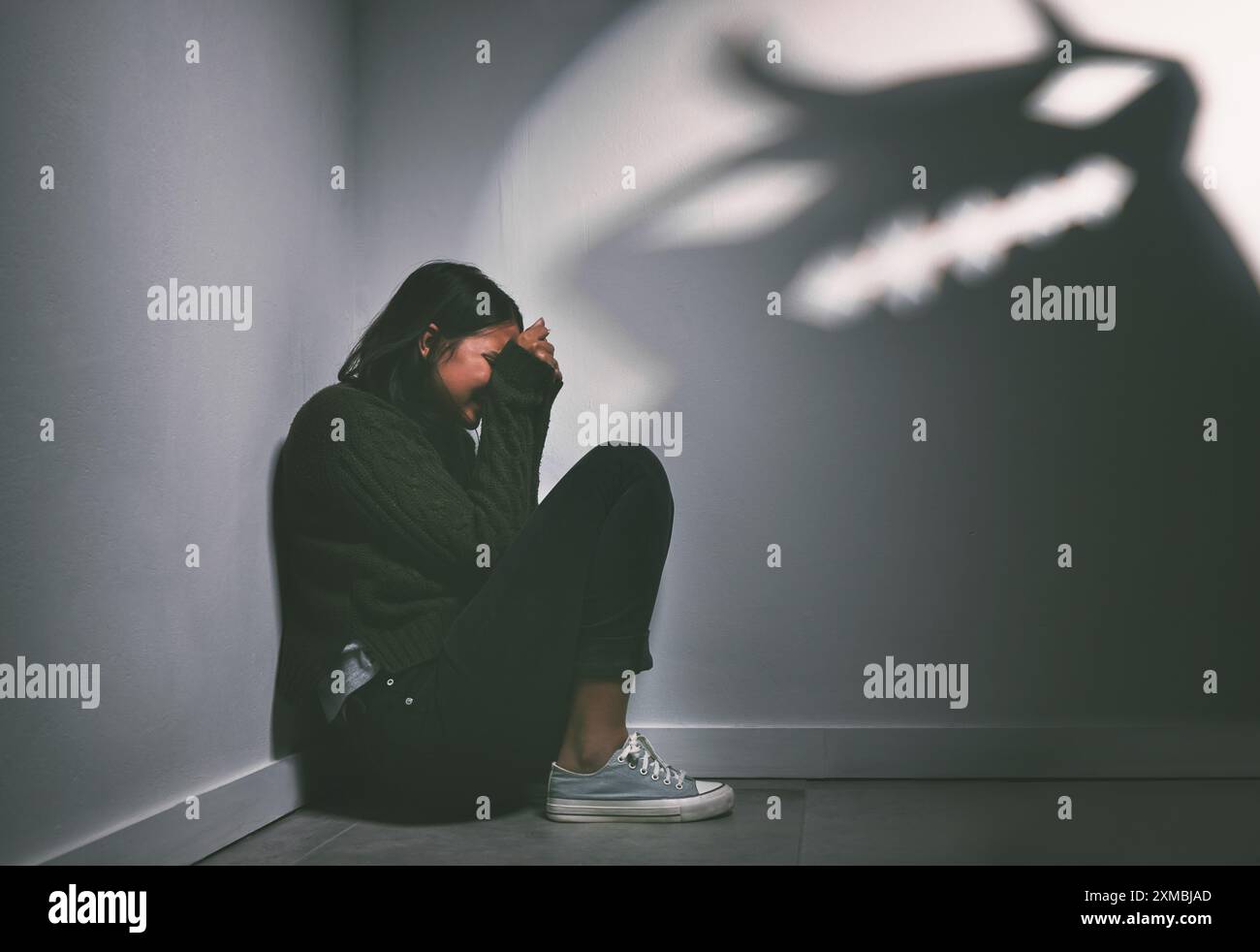 Scared woman alone dark room hi-res stock photography and images - Alamy