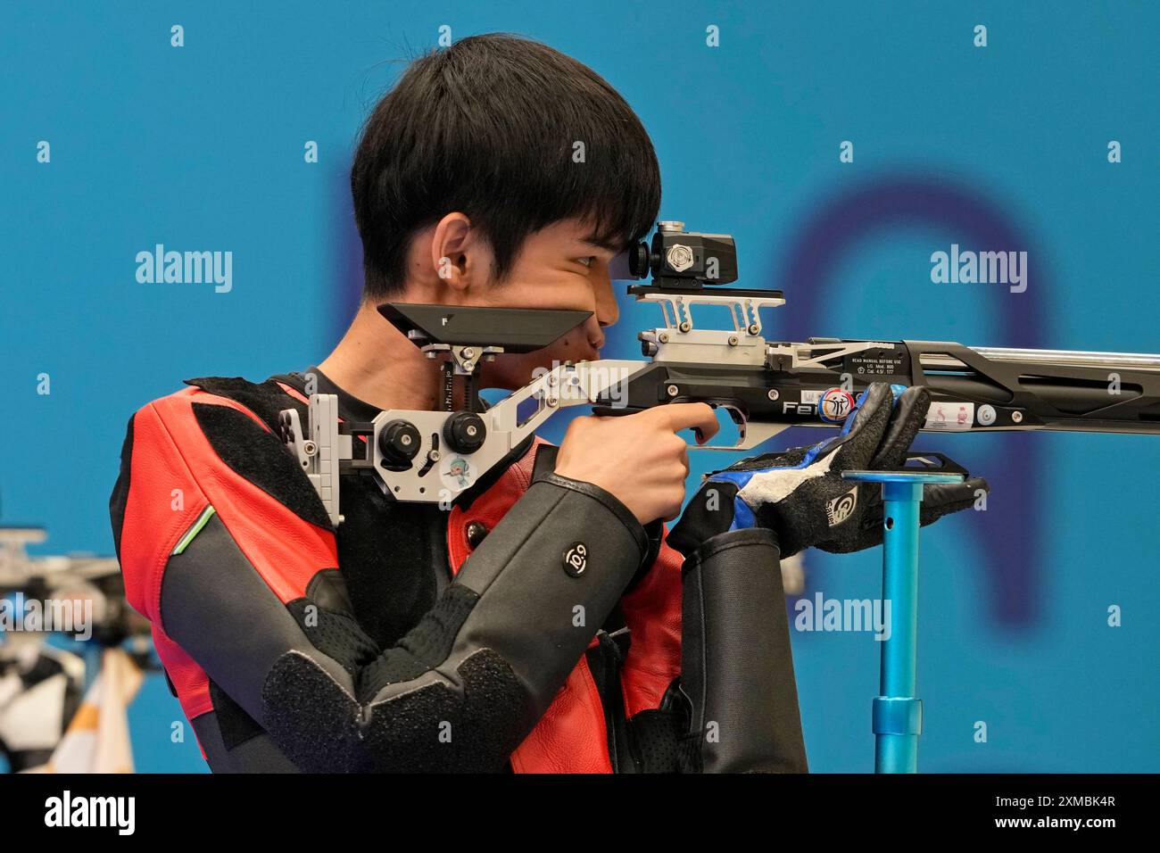 China's Sheng Lihao takes aim for the final shot in the 10m air rifle ...