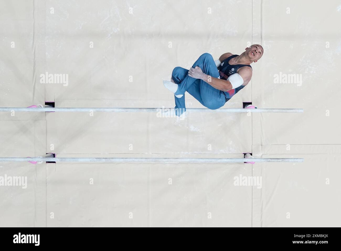Joe Fraser, of Great Britain, performs on the parallel bars during a ...