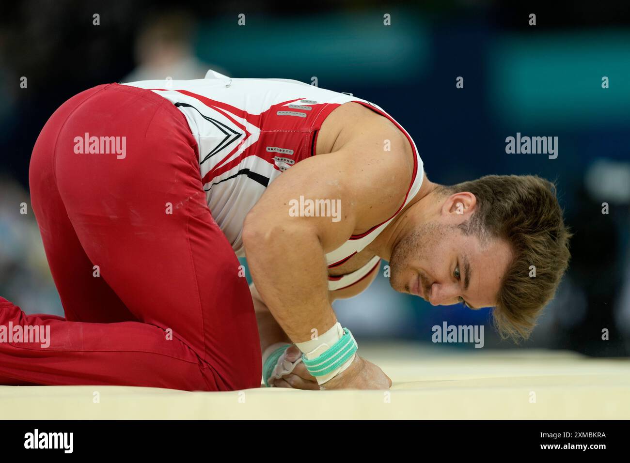 William Emard, of Canada, falls while competing on the high bar during ...