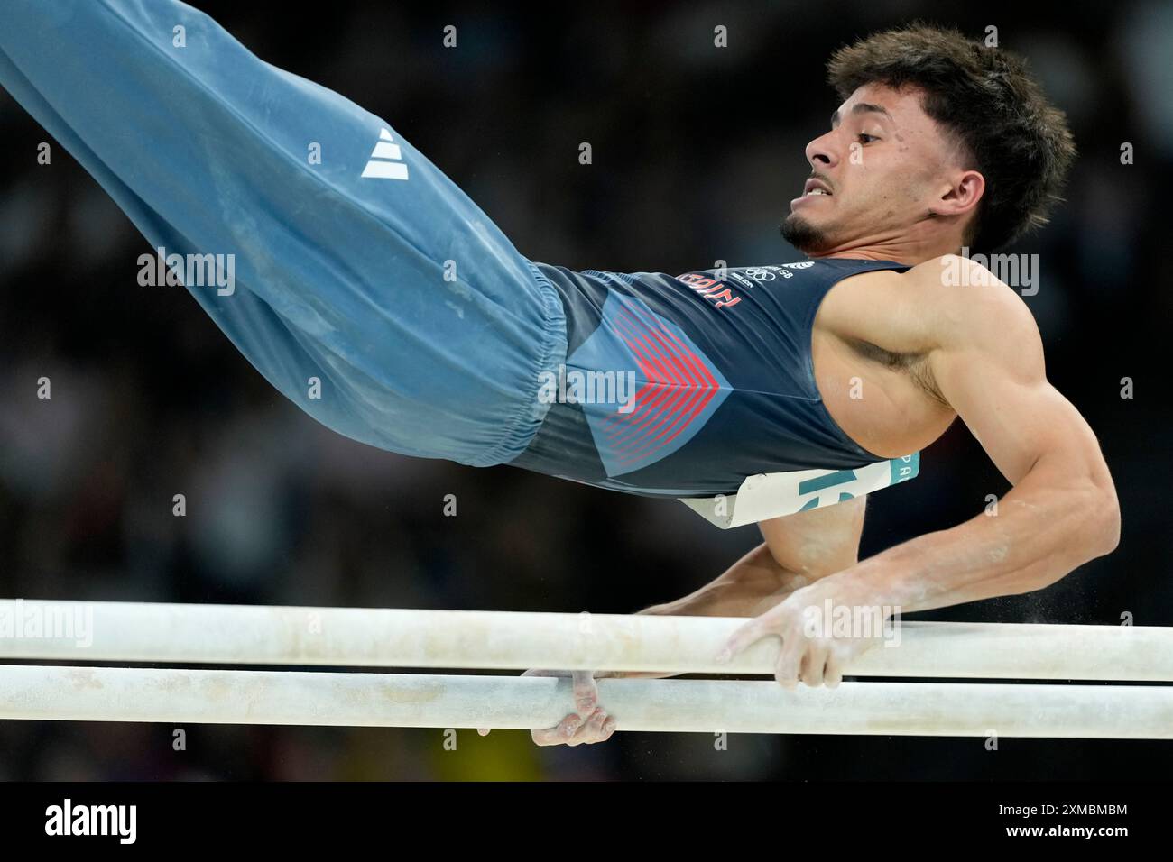 Jake Jarman, of Great Britain, competes on the parallel bars during a ...