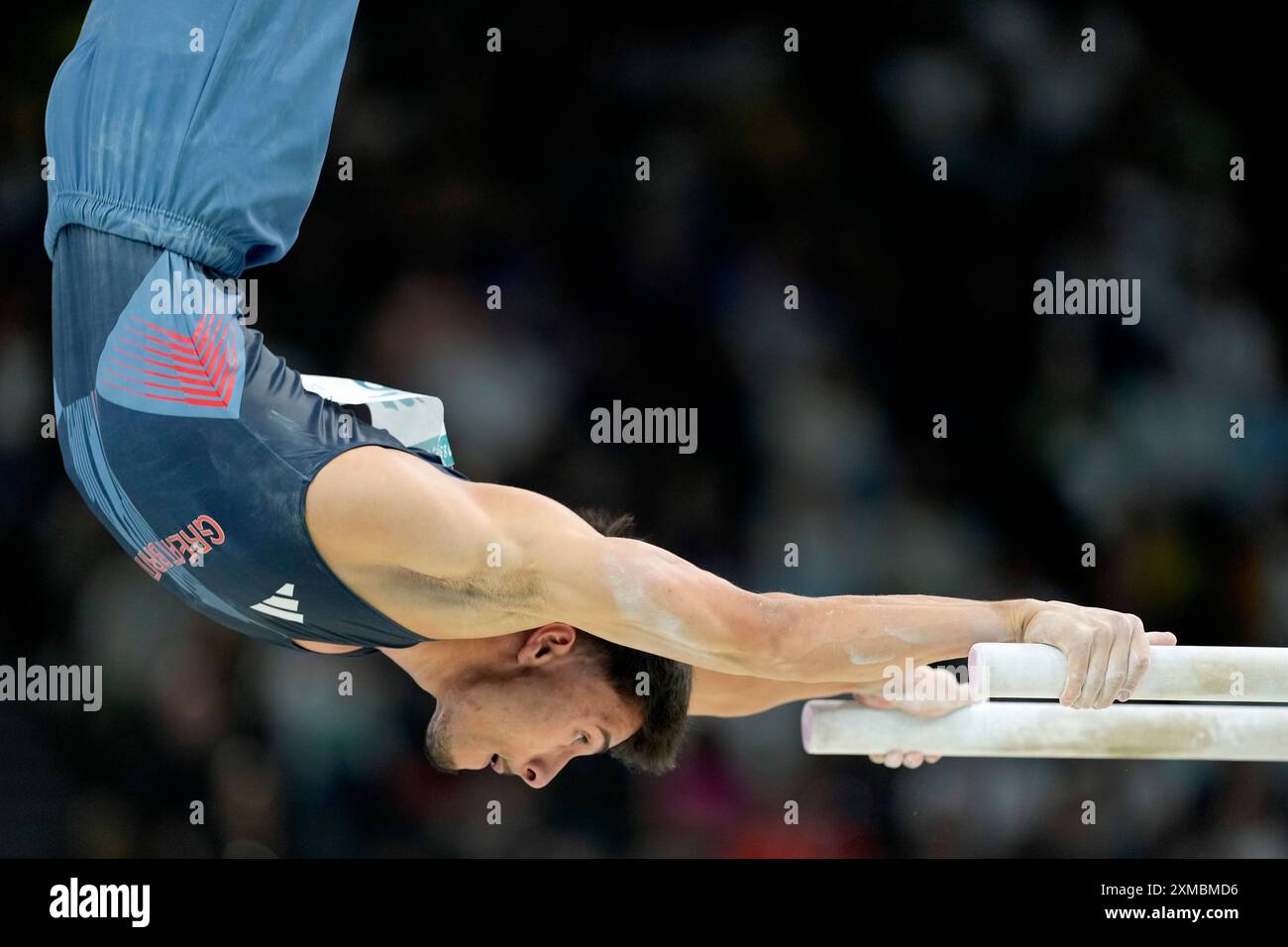 Jake Jarman, of Great Britain, competes on the parallel bars during a ...