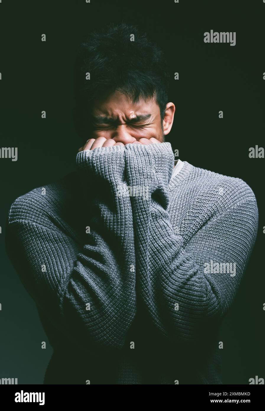 Stress, crying and man in dark studio with hands on face in fear ...