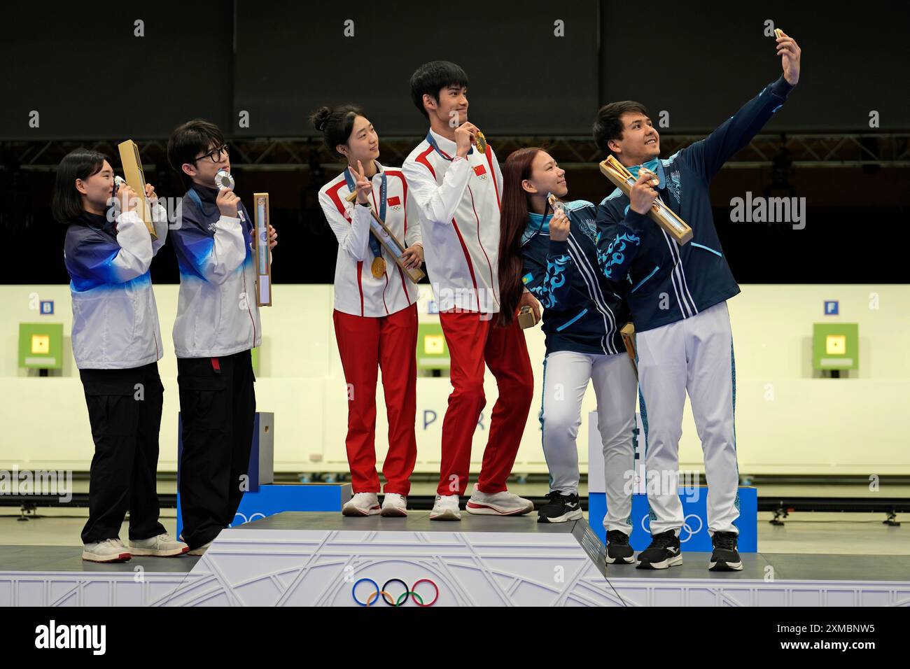 Islam Satpayev, right, of Kazakhstan uses his phone to take a selfie ...