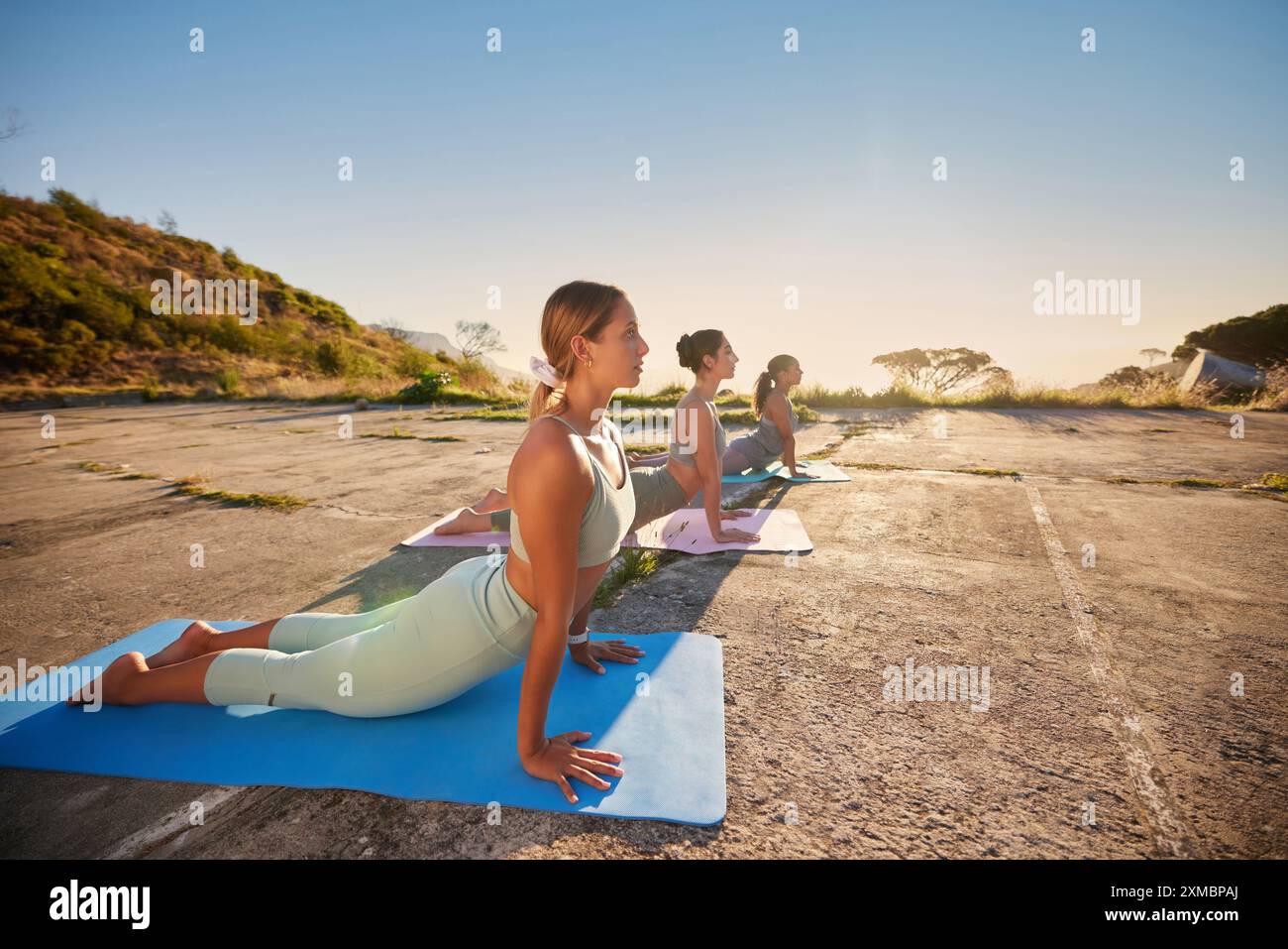 Women, stretching and group for yoga outdoor on mat for fitness ...