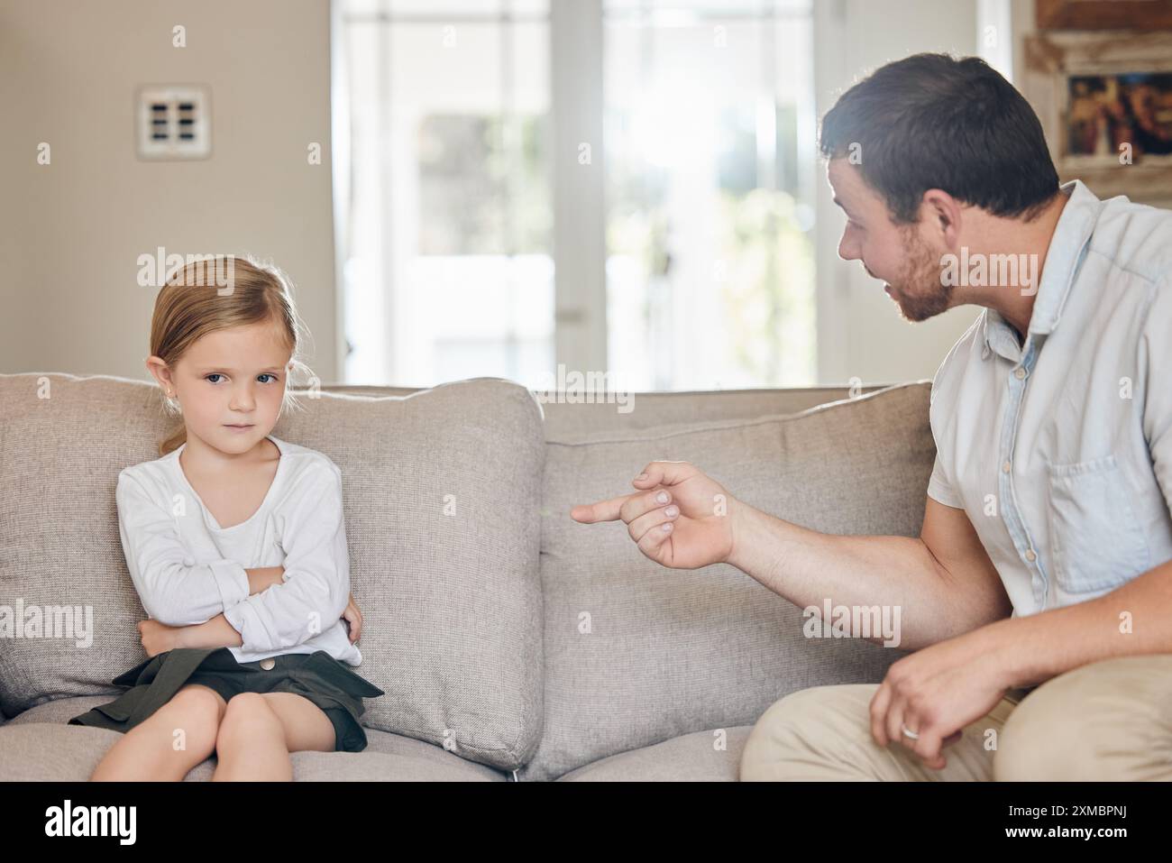 Upset, child and dad with discipline on sofa for bad behaviour ...