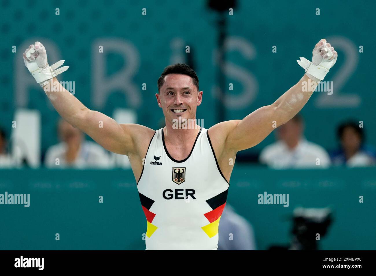 Andreas Toba, of Germany, celebrates after competing on the rings ...