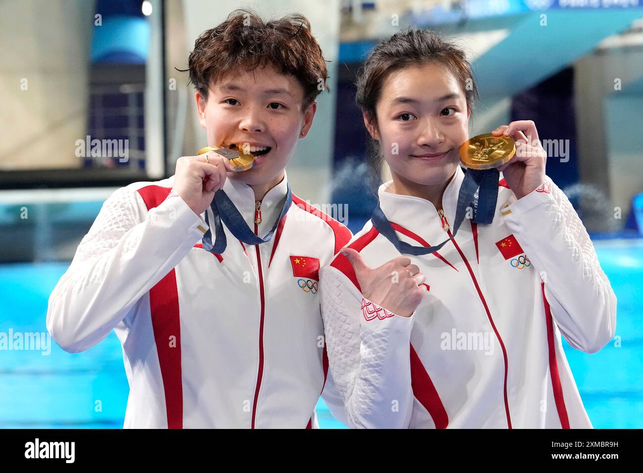 China's Chen Yiwen and Chang Yani hold their gold medal on the podium ...