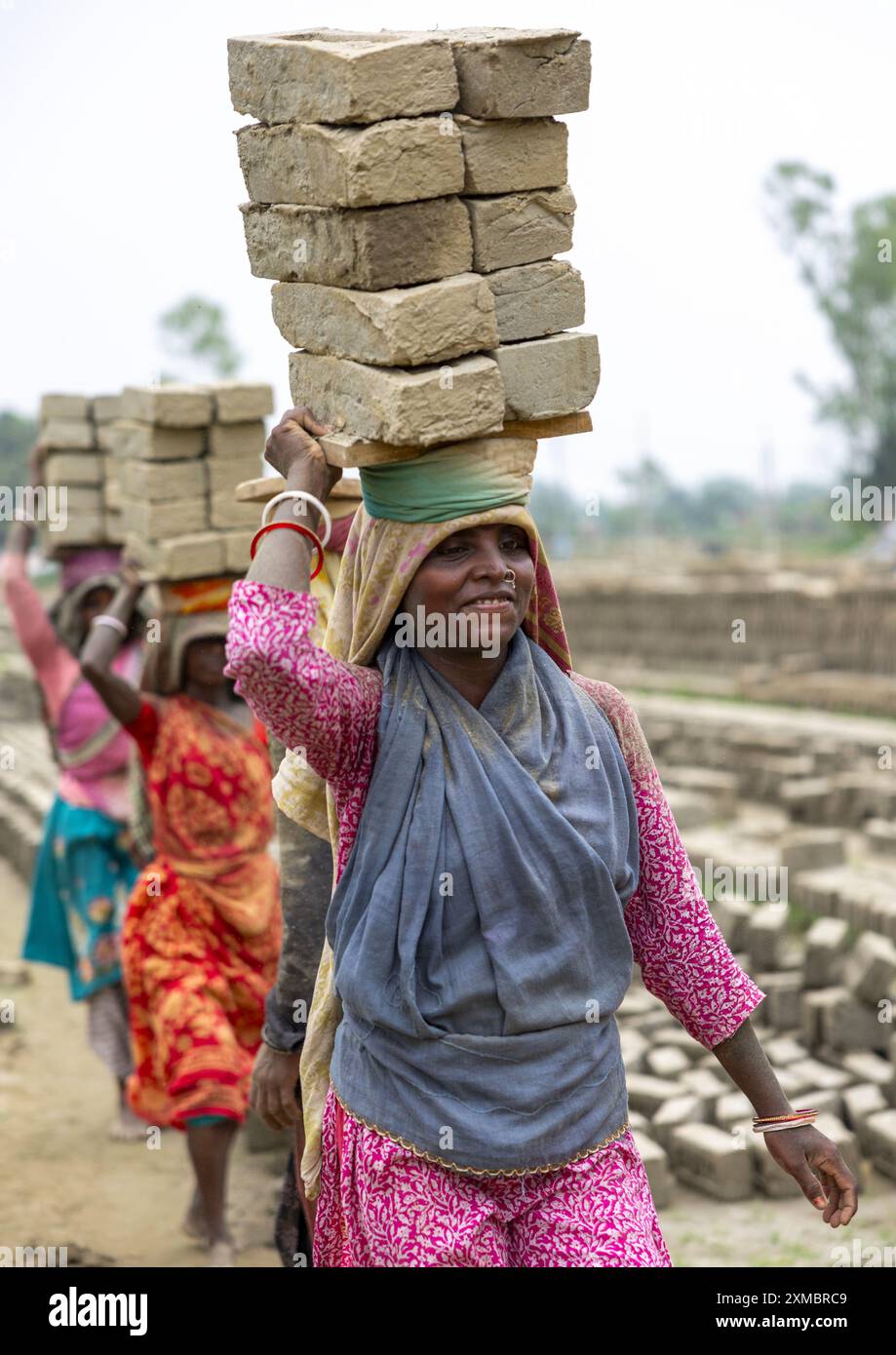 Women carrying bricks on their heads at a brick factory, Sylhet ...
