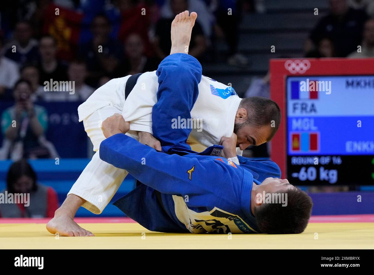 Mongolia's Ariunbold Enkhtaivan, bottom, and France's Luka Mkheidze ...
