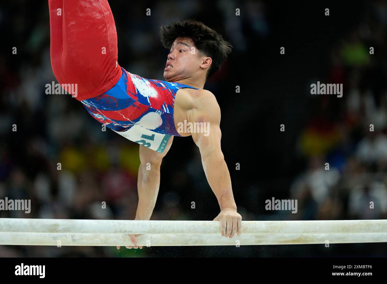 Asher Hong, of United States, competes on the parallel bars during a ...