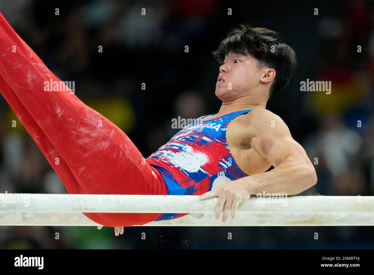 Asher Hong, of United States, competes on the parallel bars during a ...