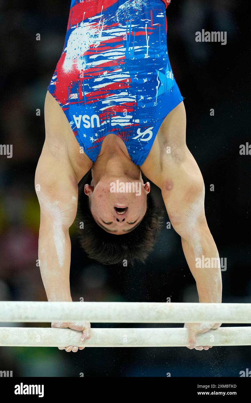 Asher Hong, of United States, competes on the parallel bars during a ...