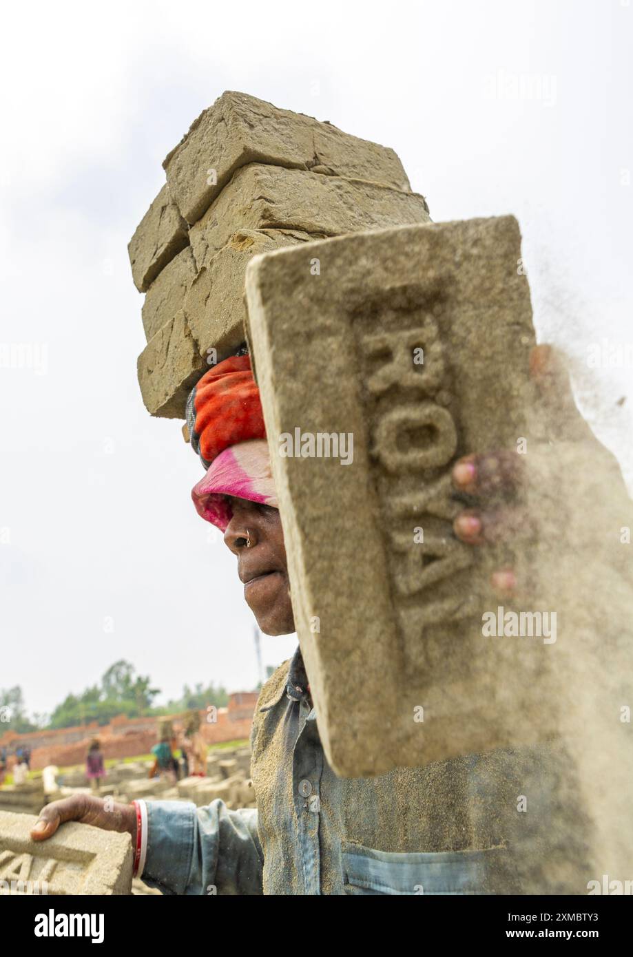 Man carrying heavy brick hi-res stock photography and images - Alamy