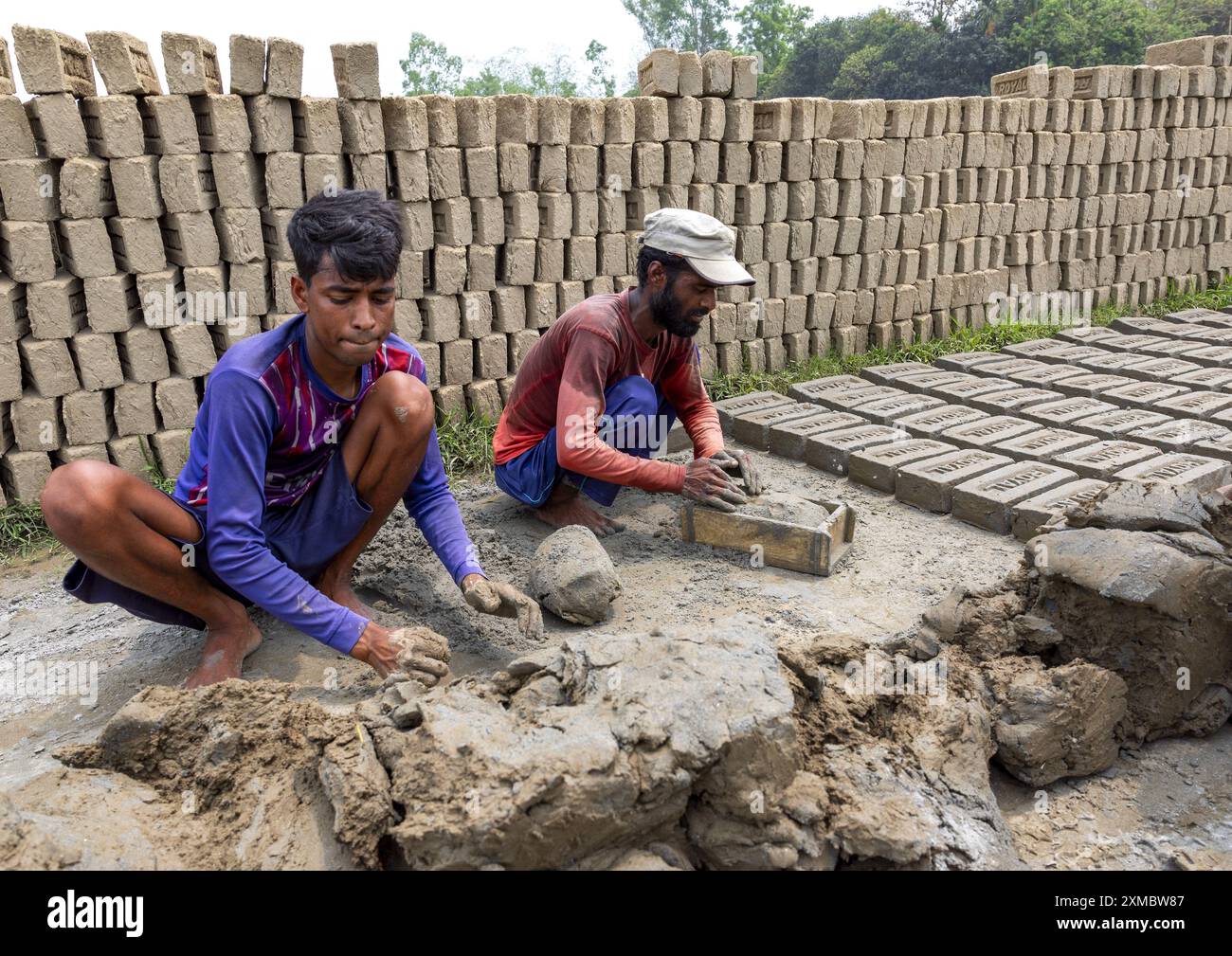 Worlers putting clay in a brick mould, Sylhet Division, Bahubal ...