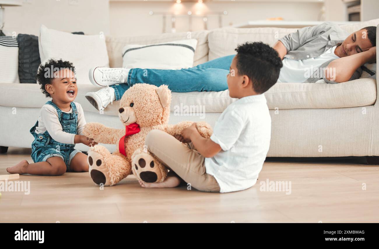 Fighting, sibling rivalry and teddy bear with children on floor of ...