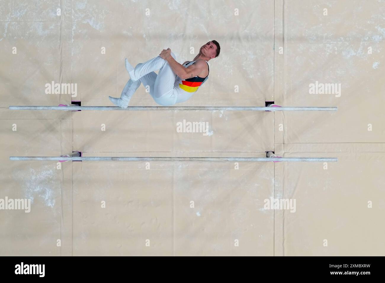 Lukas Dauser, of Germany, performs on the bars during a men's artistic ...