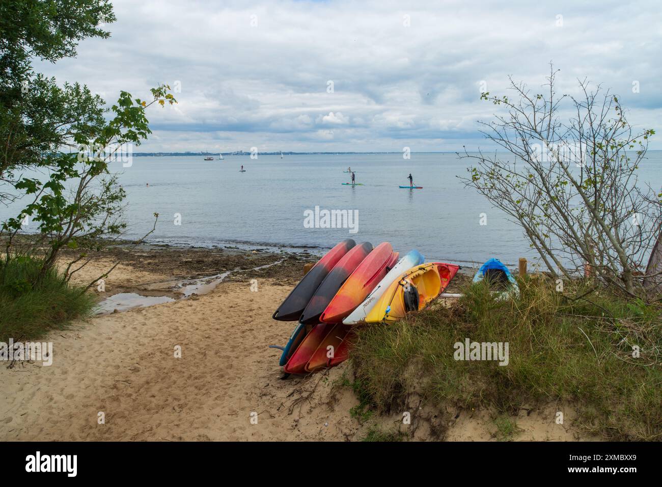 Middle Beach, Studland, UK - July 23rd 2024: Kayaks stacked up on the ...