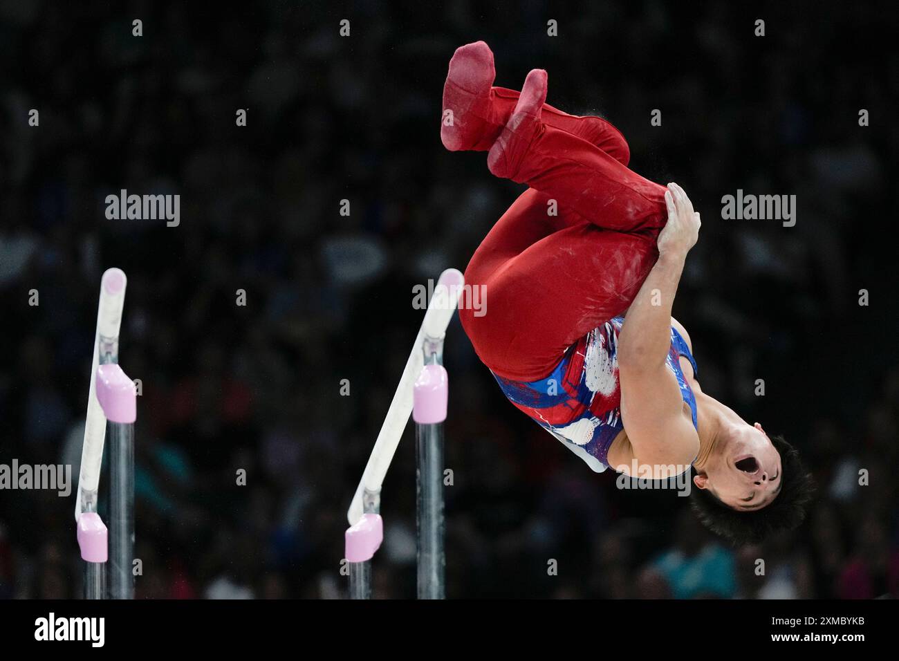 Asher Hong, of United States, competes on the parallel bars during a ...