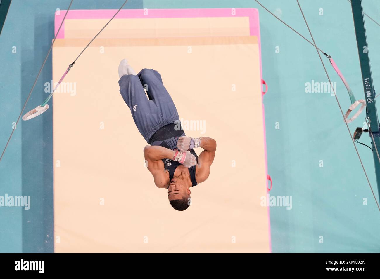Joe Fraser, of Great Britain, performs on the rings during a men's ...