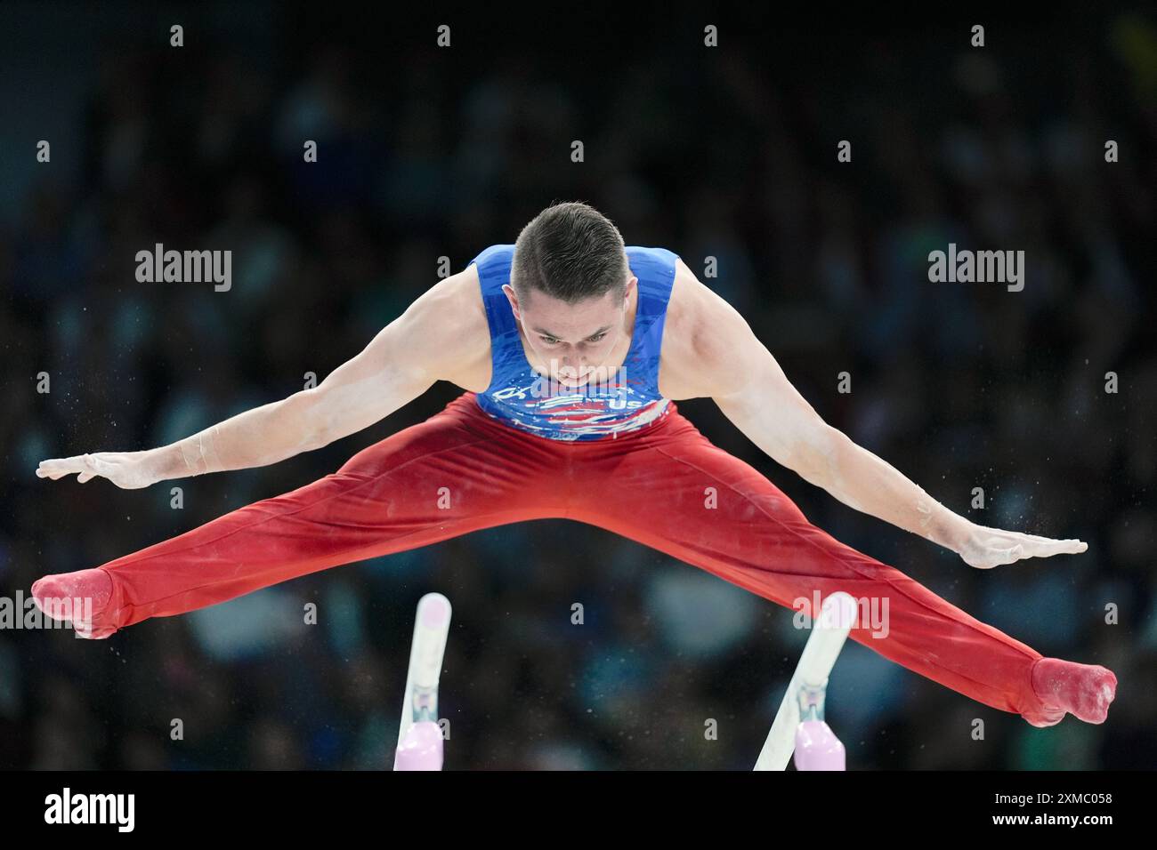 Paul Juda, of United States, competes on the parallel bars during a men ...