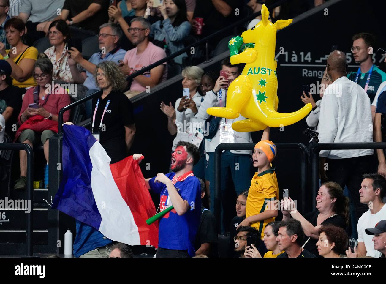 Supporters react as they watch a heat of the women's 4 x 100m freestyle ...