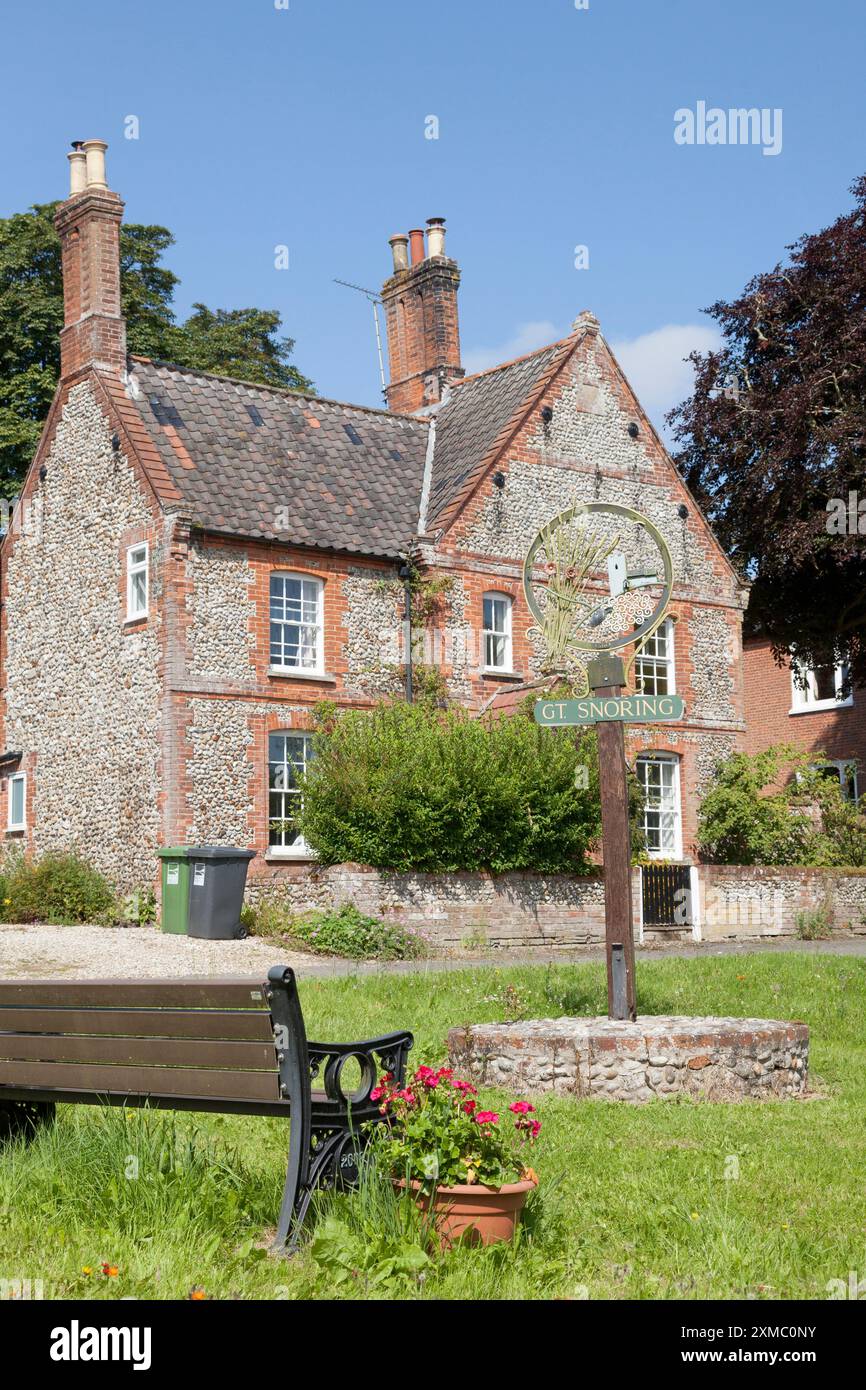 Village green, village sign and flint and brick buildings, Great ...