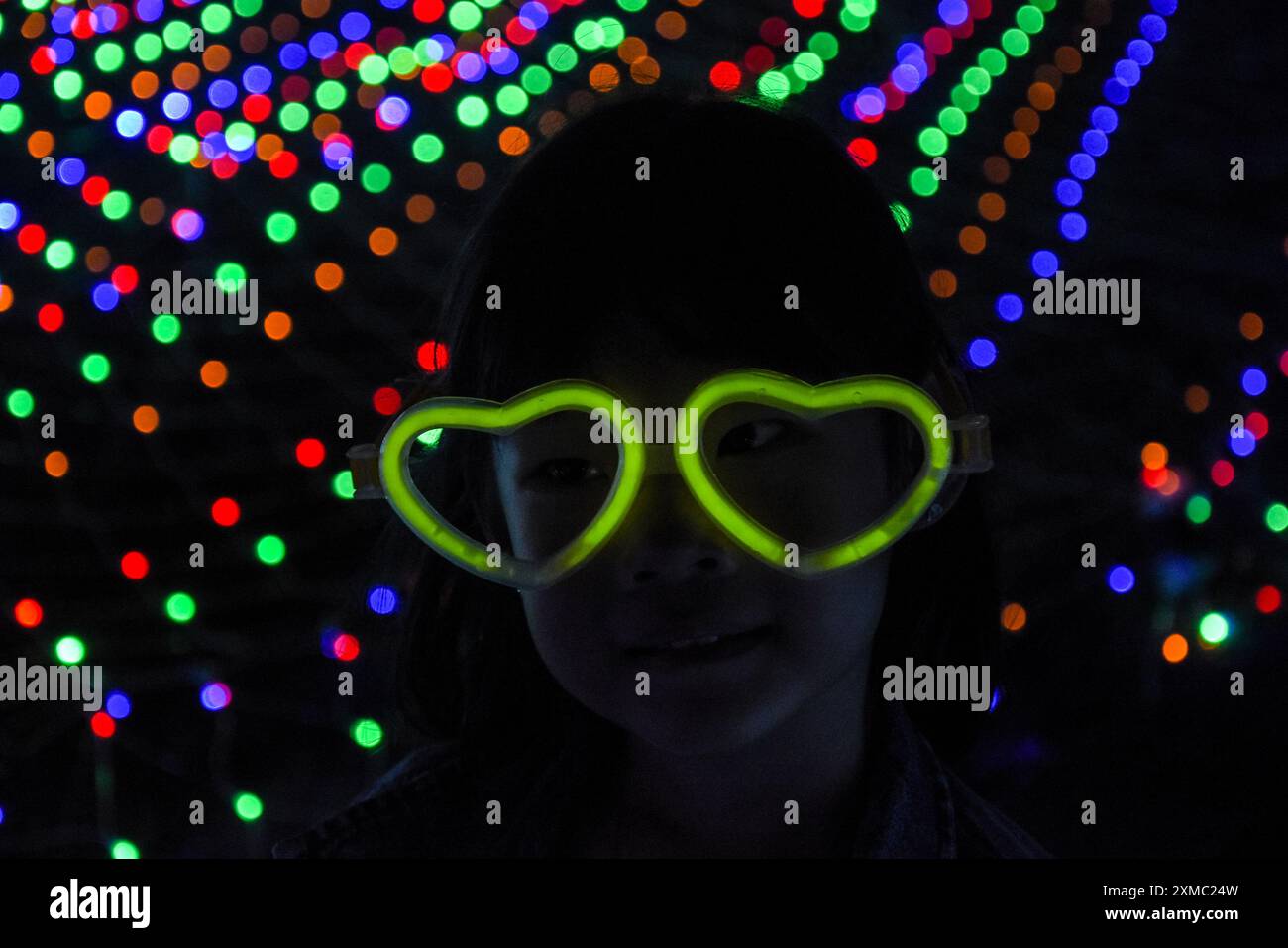 A child wears glow stick glasses in the galaxy playground at Paris Van ...