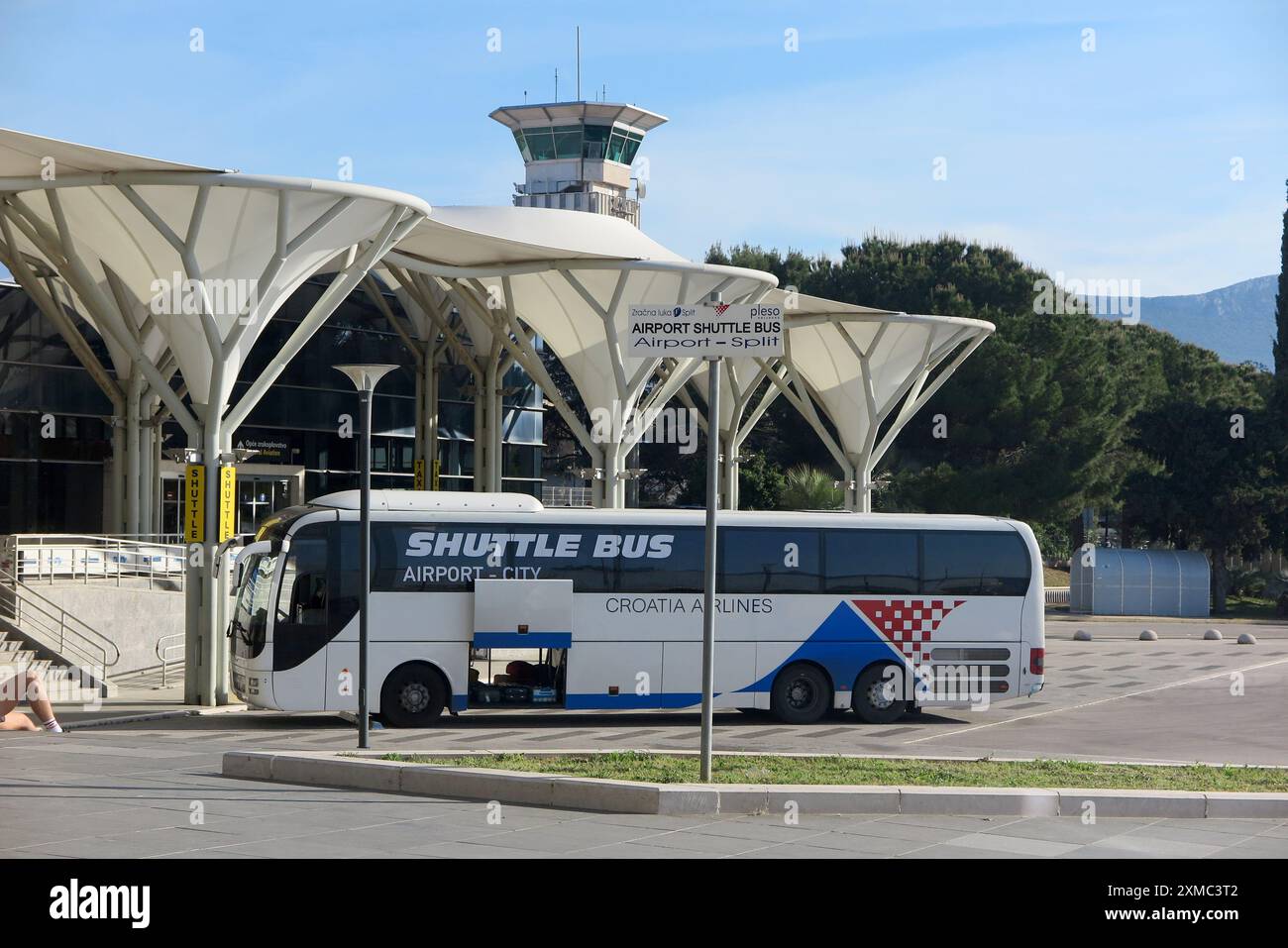 Tourist passenger shuttle bus at Split Airport, in front of the main terminal building with ...