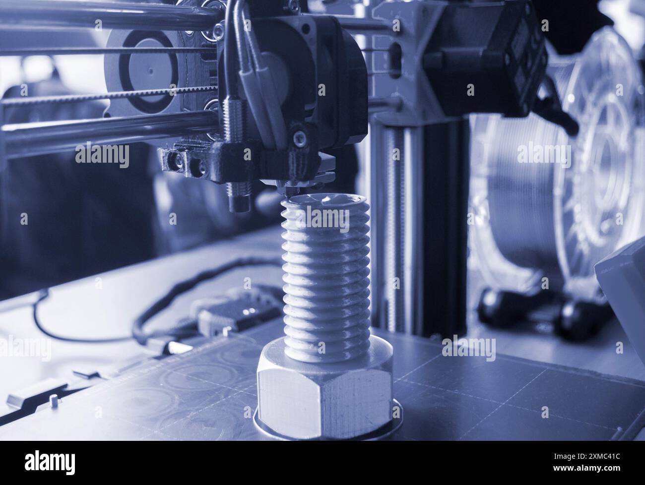 3D printer printing prototype of bolt from molten plastic. Process of ...