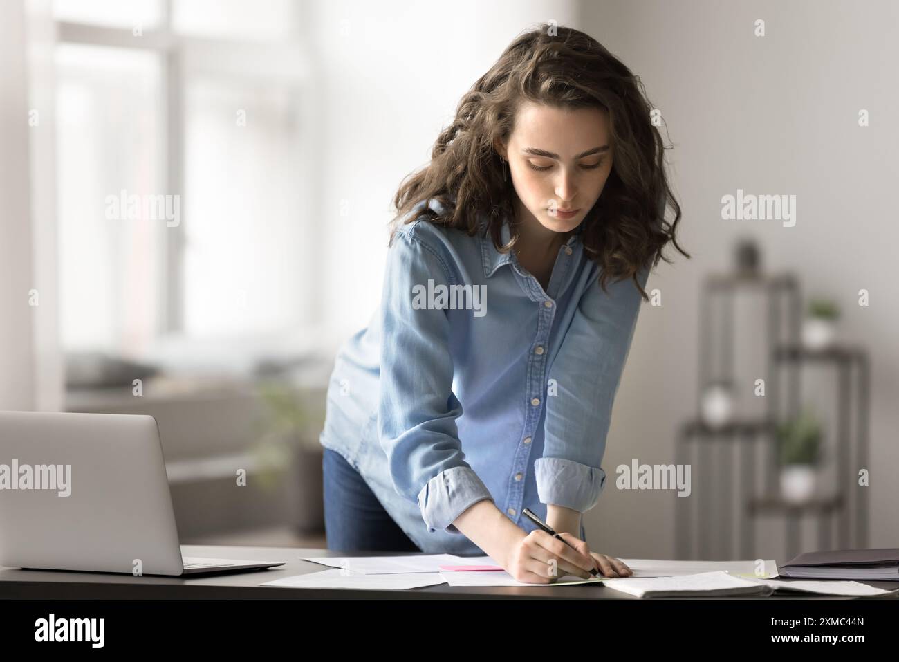 Attentive woman making notes hi-res stock photography and images - Alamy