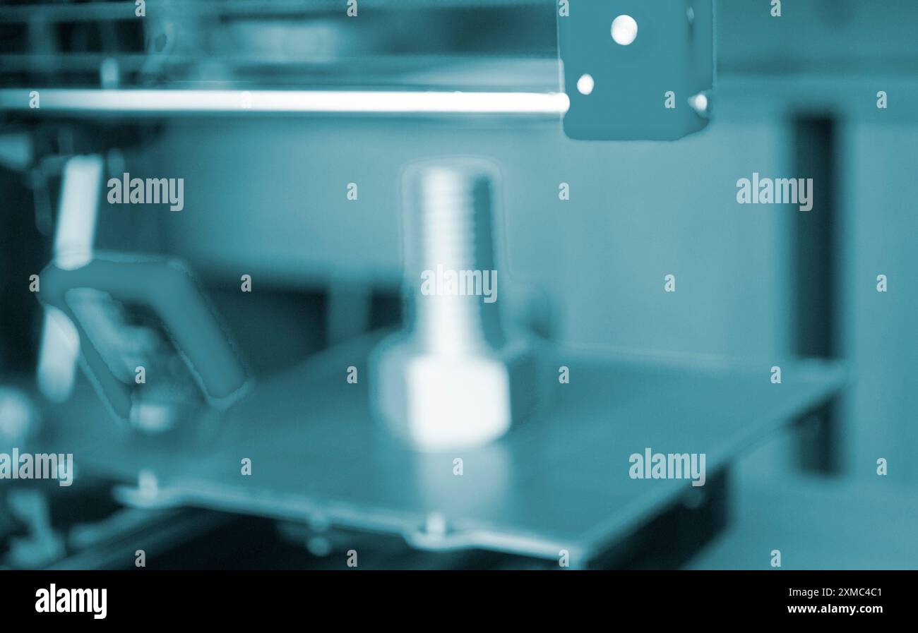 3D printer printing prototype of bolt from molten plastic. Creating ...