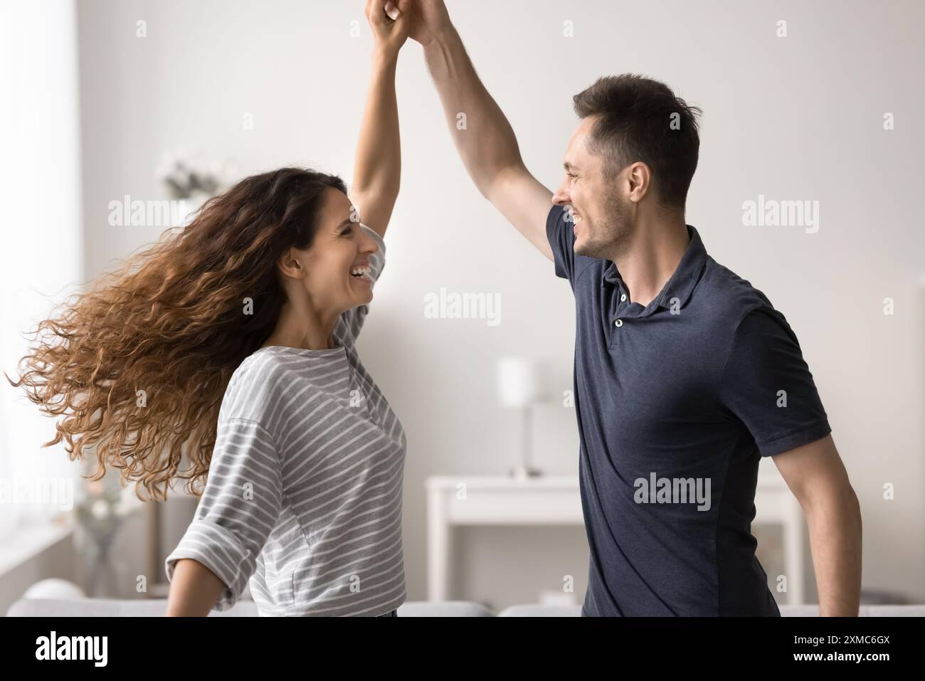 Happy romantic couple in love having fun, dancing at home Stock Photo ...
