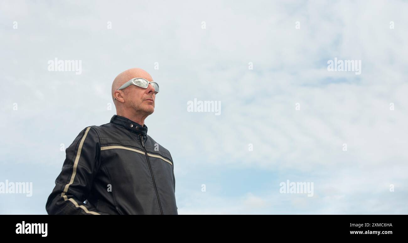 Attractive bald man with sunglasses and leather jacket. Outdoors with ...