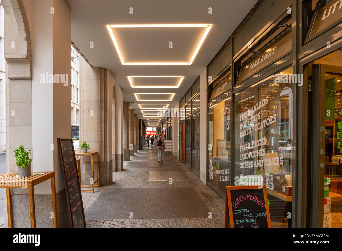 Berlin, Germany, July 26, 2024. A long arch lined with shop windows ...
