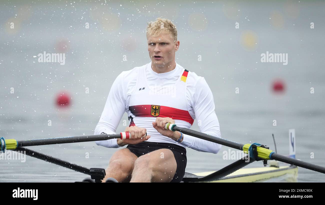 Oliver Zeidler, of Germany, finishes the men's rowing single sculls ...