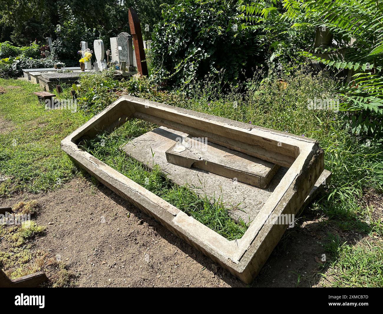 Damaged broken tombstone in the public cemetery Stock Photo - Alamy
