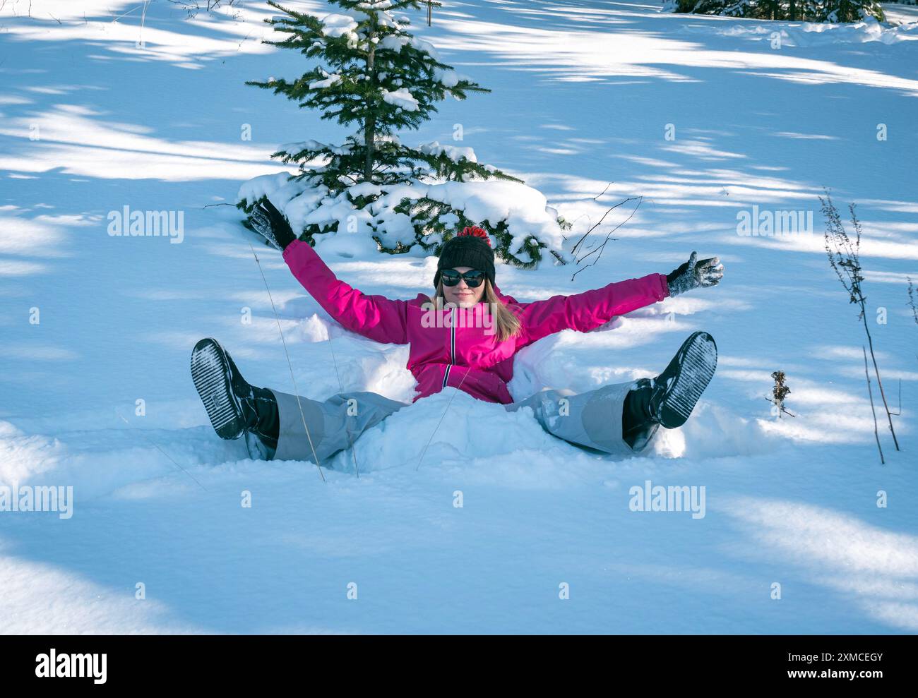 Young woman joyfully enjoying snow in a winter wonderland during ...