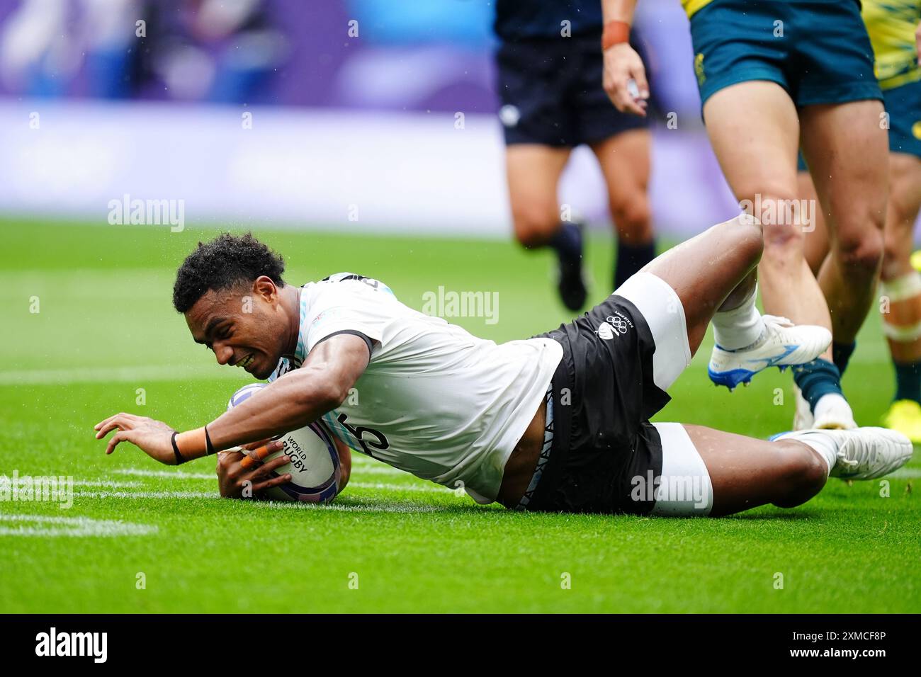Fiji's Iosefo Baleiwairiki scores a try during the rugby sevens match ...