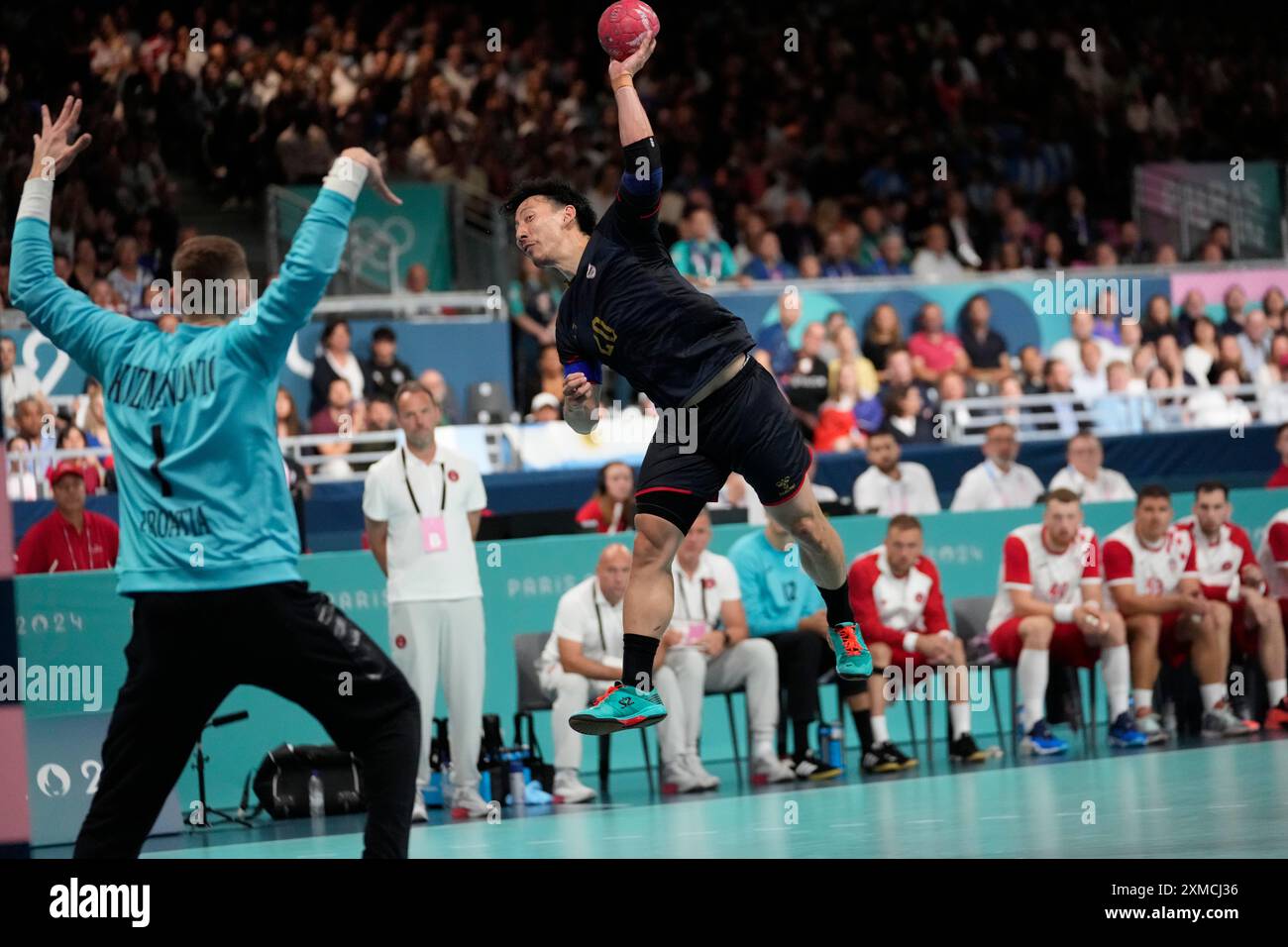 Jin Watanabe, of Japan, tries to shoot the ball past goalkeeper Dominik ...