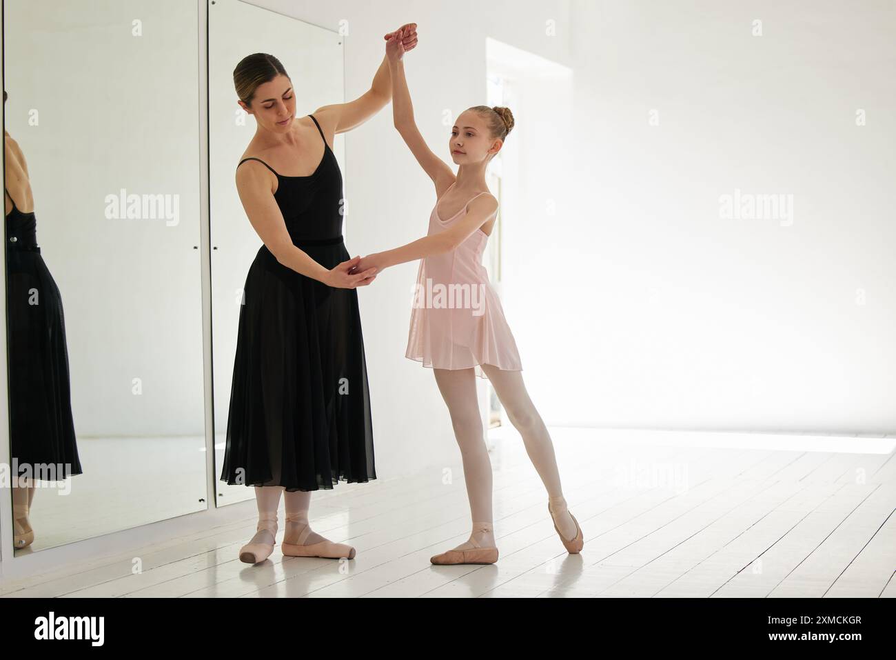 Ballet, teacher and girl in studio for learning, arms and correct ...