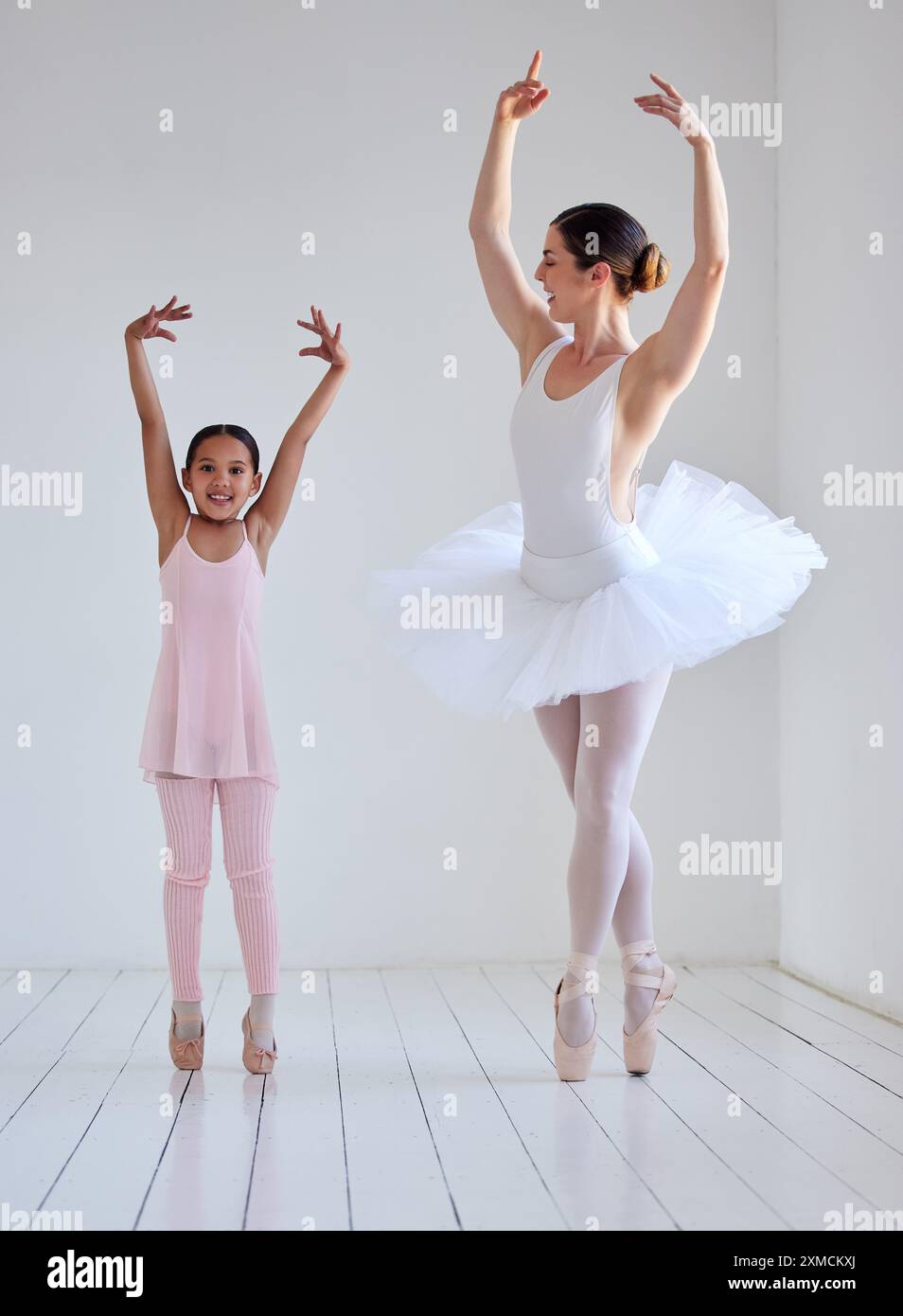 Teacher, child and learning ballet in studio, dance training and ...