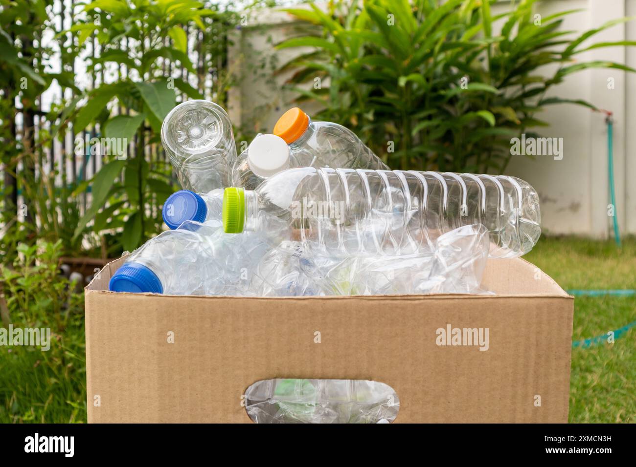 plastic bottles in brown recycle garbage box Stock Photo - Alamy