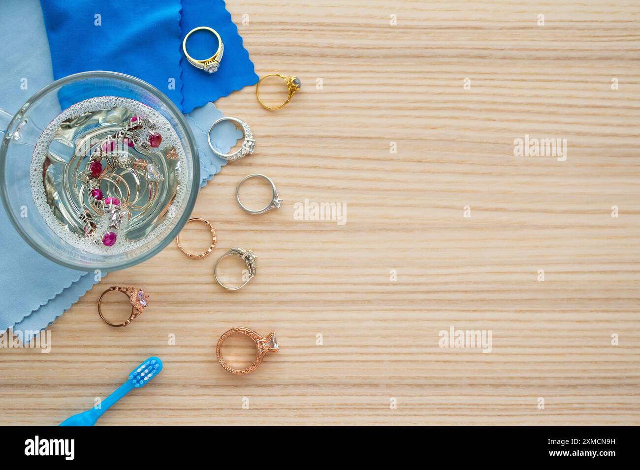 cleaning jewelry diamond ring with glass of hot water and dishwashing ...