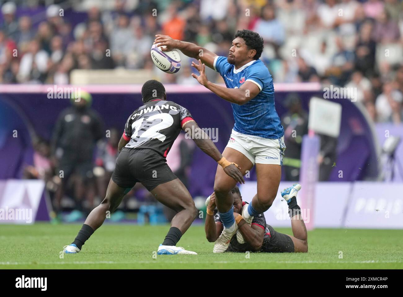 Samoa's Faafoi Falaniko gets the ball away as Kenya's Chrisant Ojwang ...