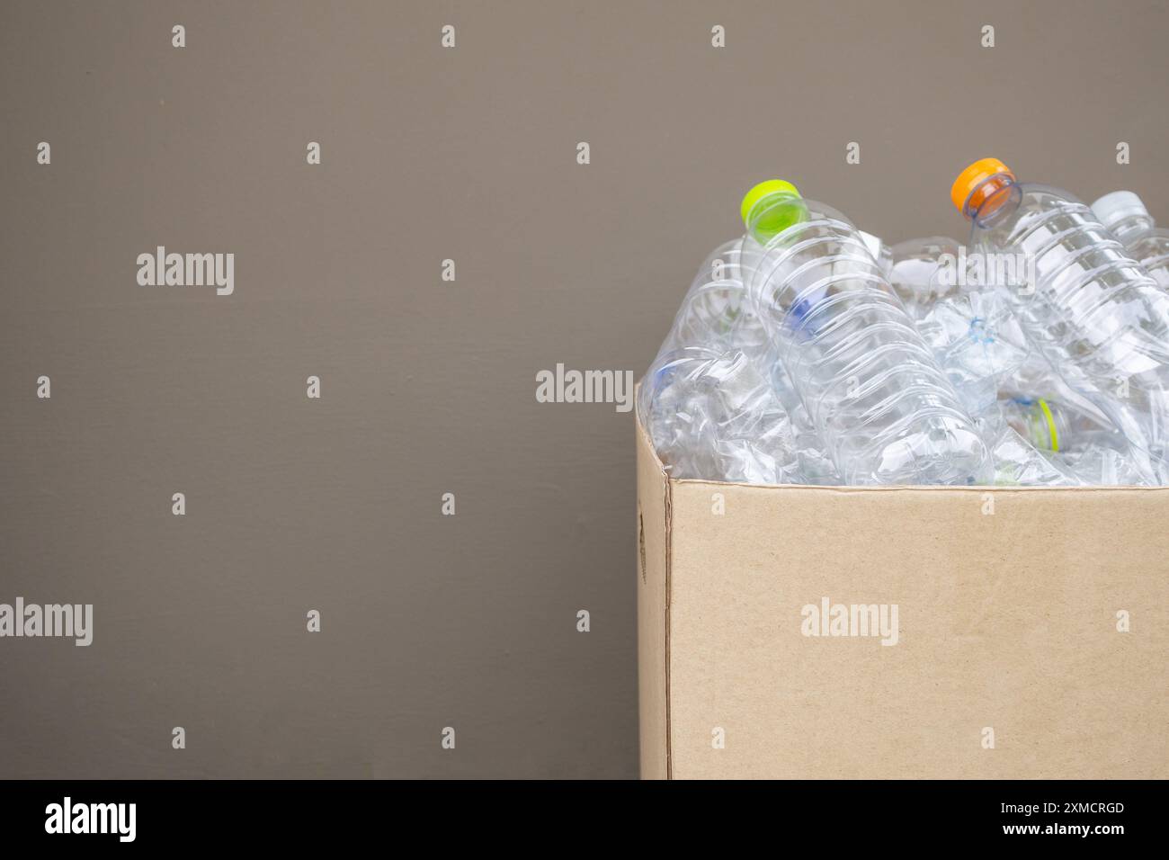 plastic bottles in brown recycle garbage box Stock Photo - Alamy