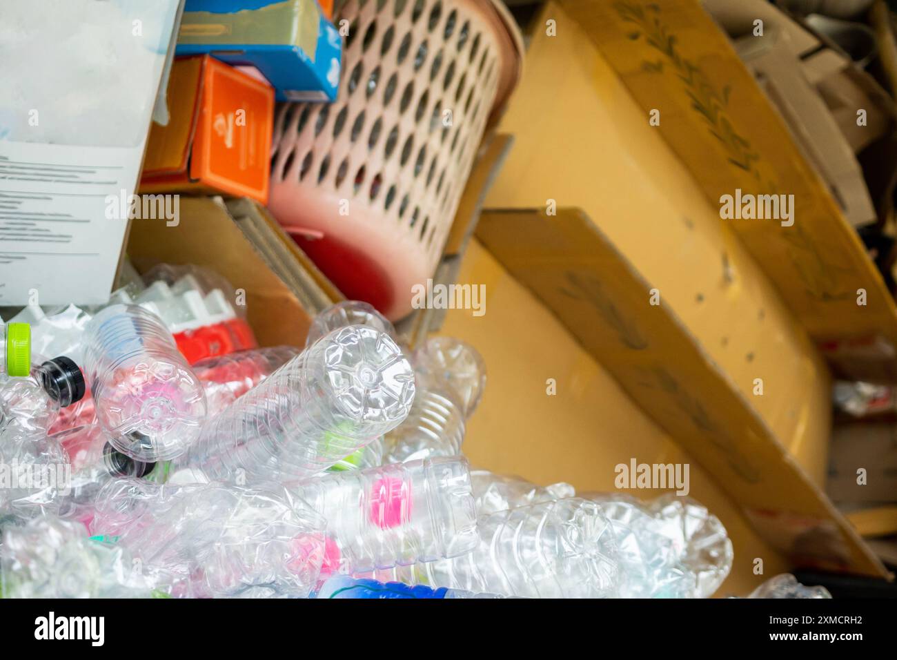 plastic bottles and cardboard paper in recycle trash station close up ...