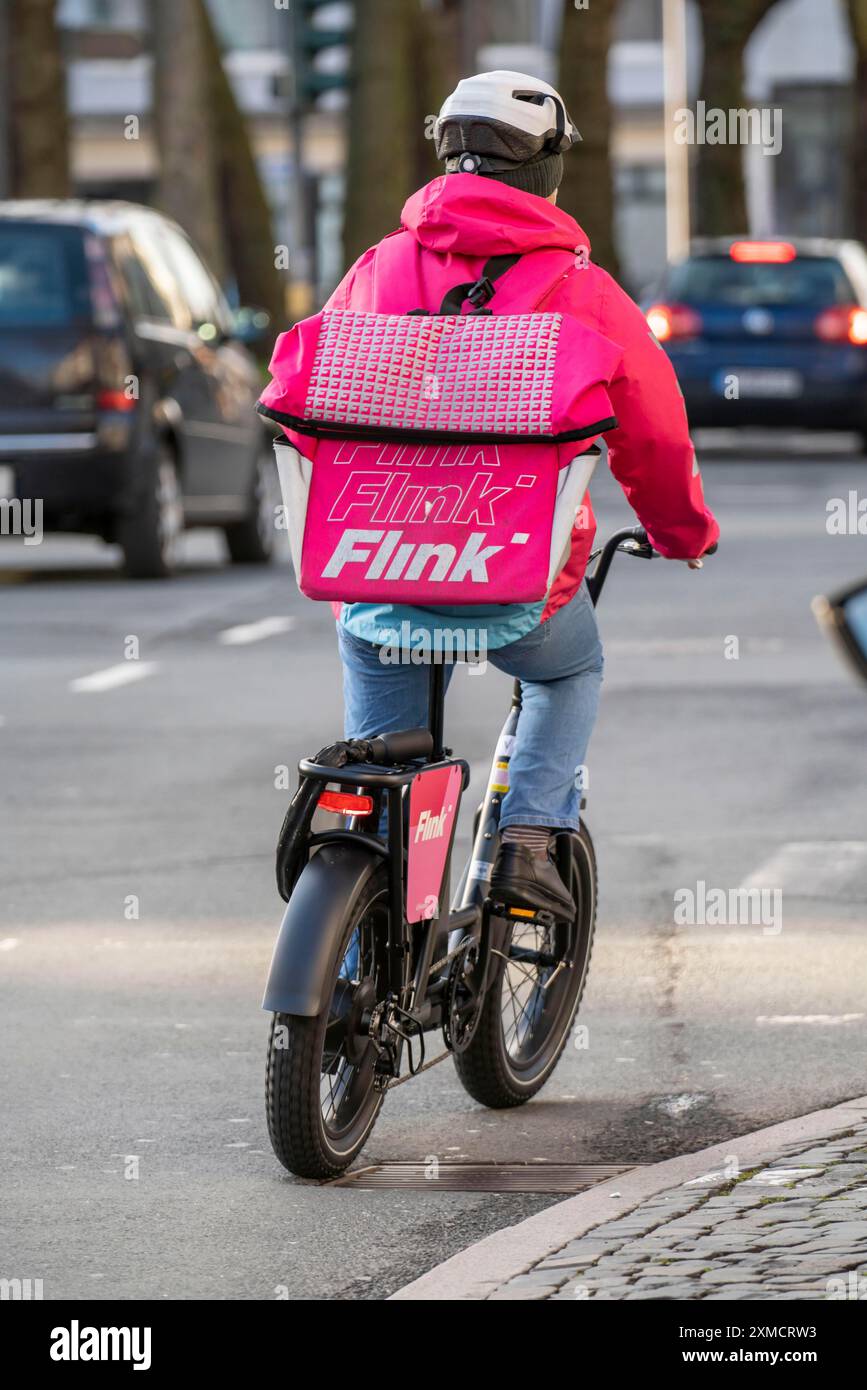 Bicycle courier of the Flink express delivery service, delivers ...